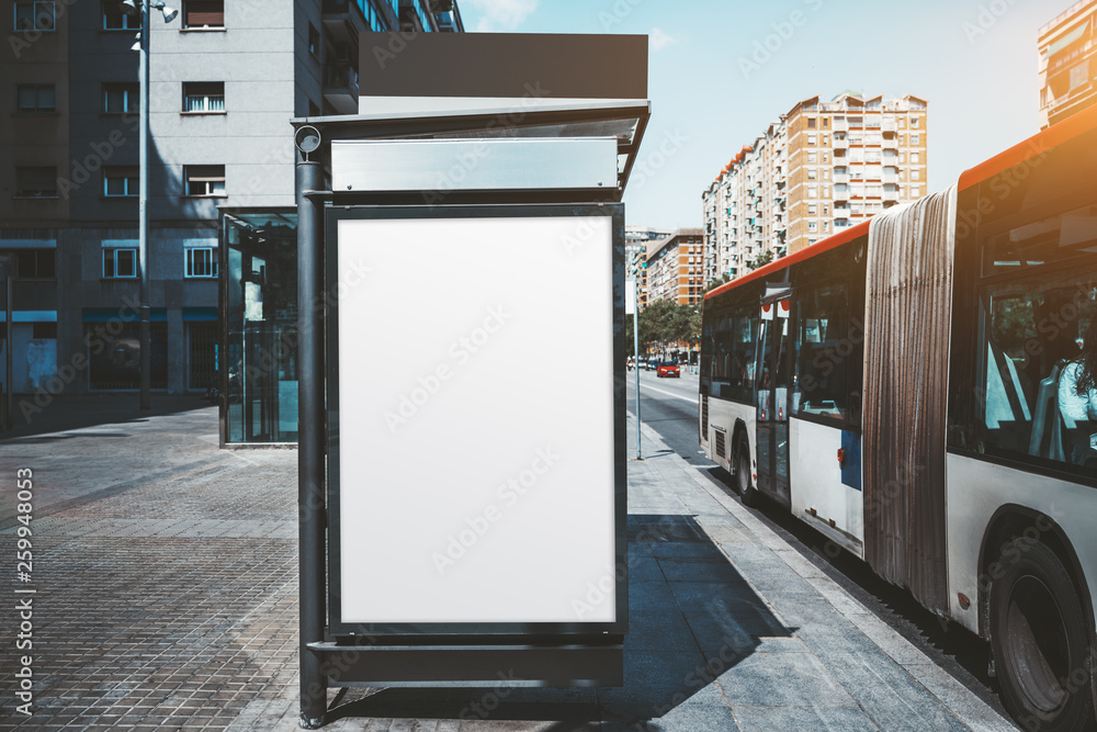 An empty poster mock-up on an outer side of the bus stop; advertising ...