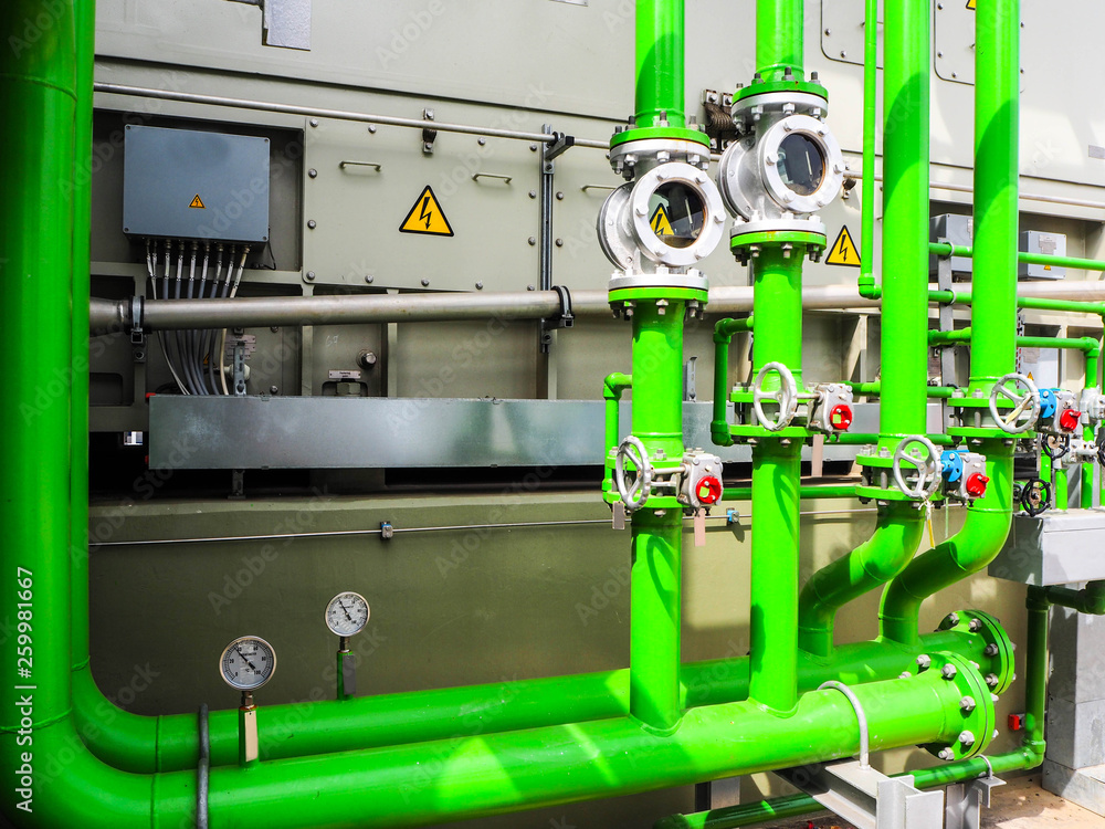 Manual valve and green pipe of cooling water in power plant. Stock ...