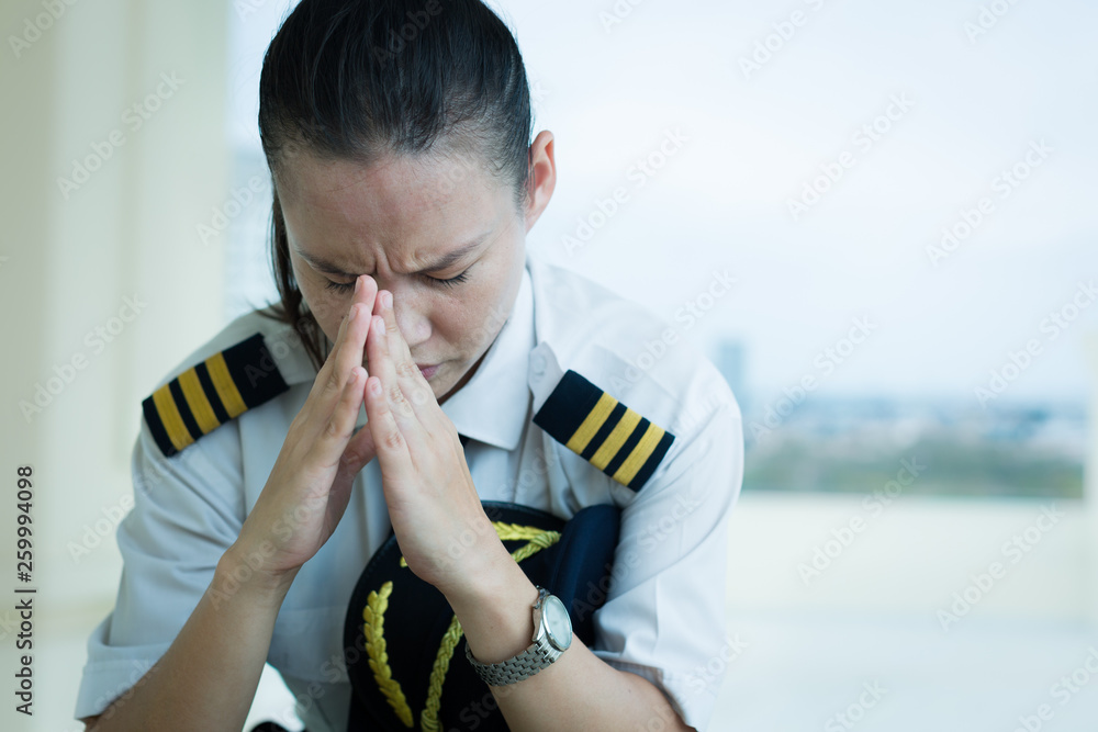 Stressed out female pilot worried at work. Stock Photo | Adobe Stock