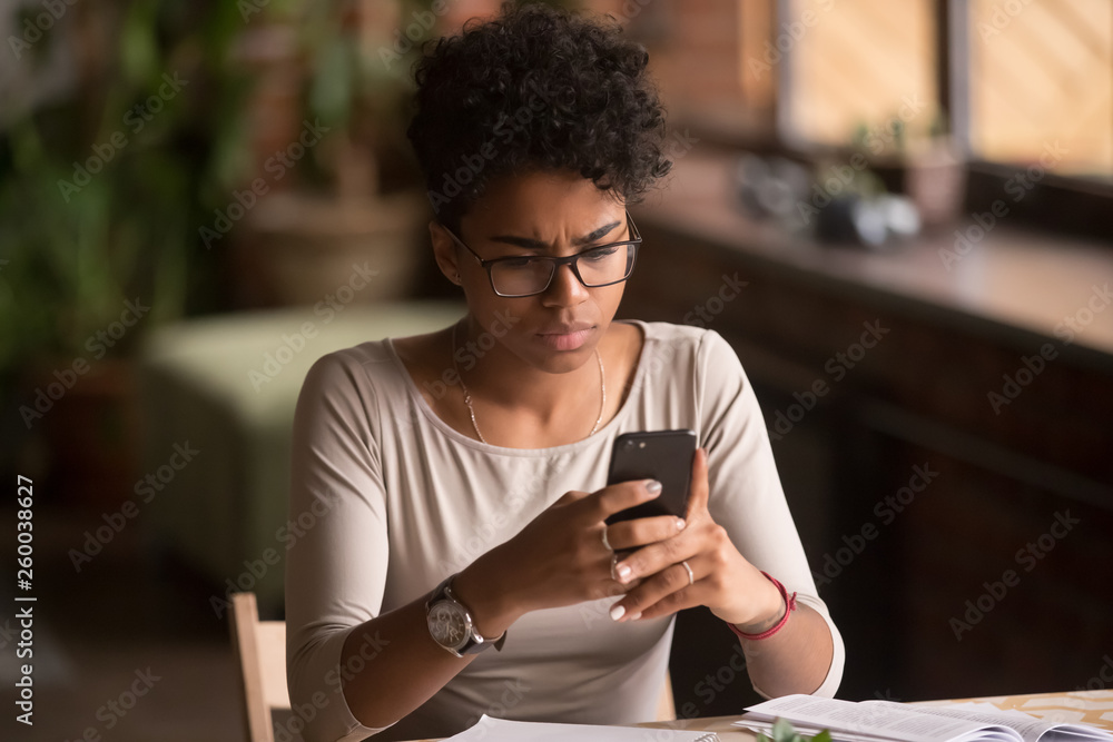Upset Confused African Woman Holding Cellphone Having Problem With