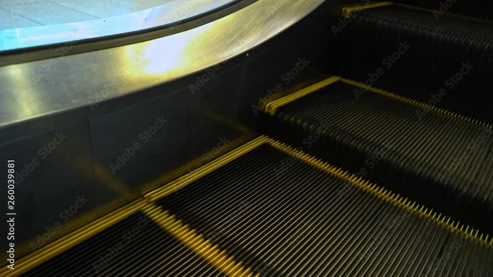 Escalator. Moving staircase in business center. Laziness. Moving steps ...