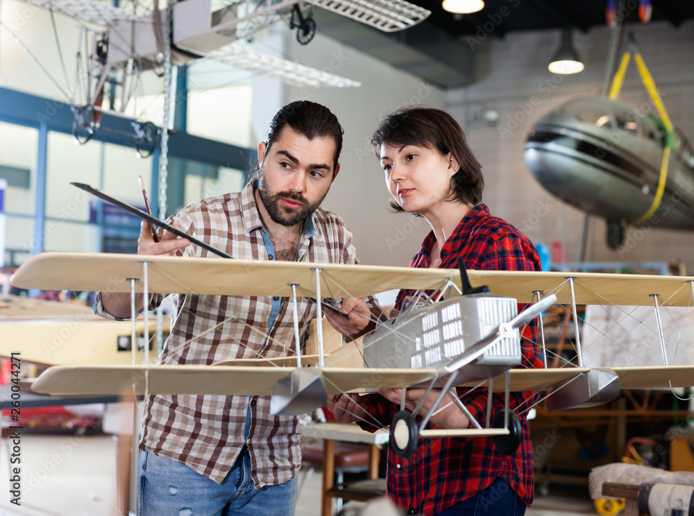Positive couple enjoying their hobbies - modeling light airplanes in ...