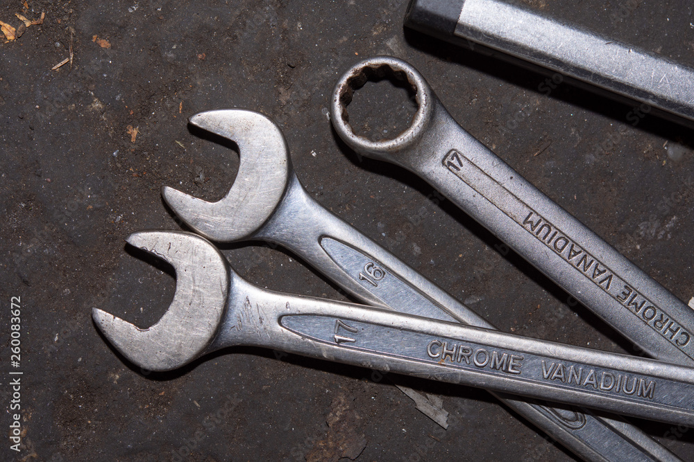 Wrench tools on a concrete floor. Dirty set of hand tools on a vintage ...