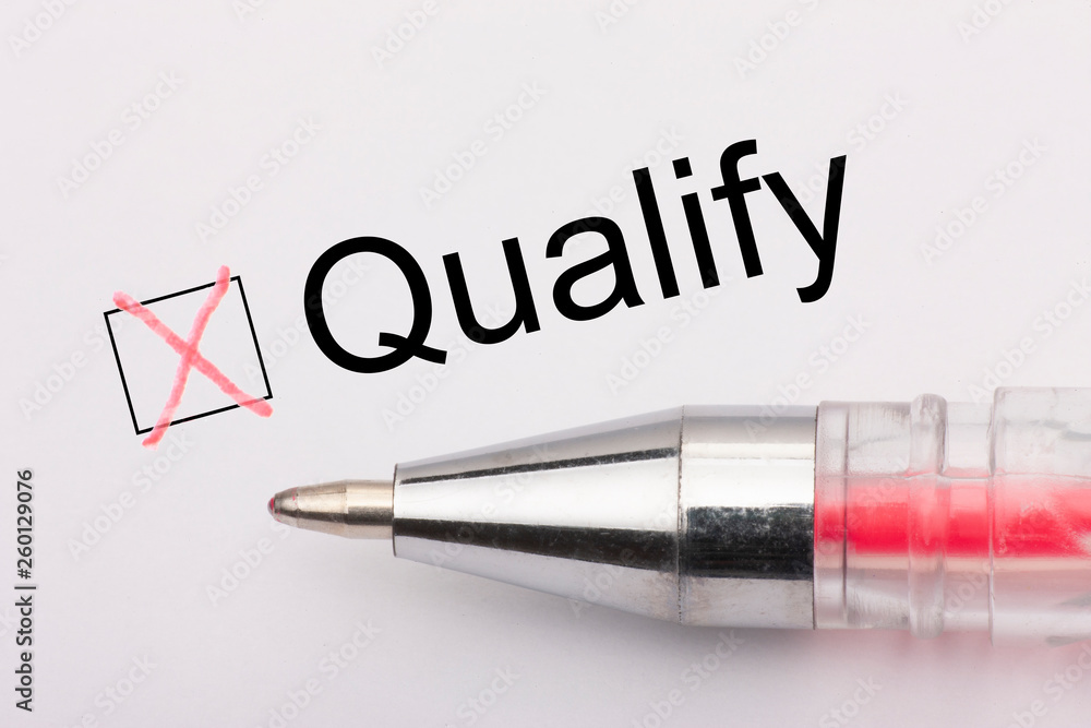 Qualify - checkbox with a cross on white paper with pen. Checklist ...