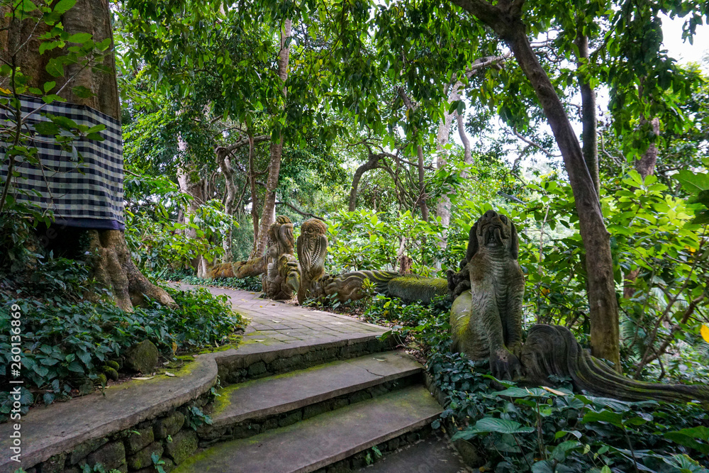 The statue in Ubud Monkey Forest covered by moss, Bali Island ...