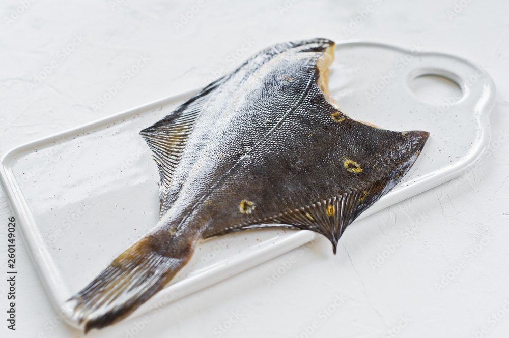 Raw plaice. White background, side view. Stock Photo | Adobe Stock