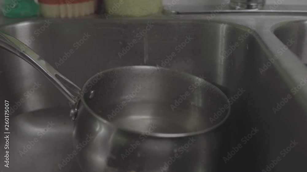 Water drips into a pot that's sittin in the sink. 4k 30p footage Stock ...