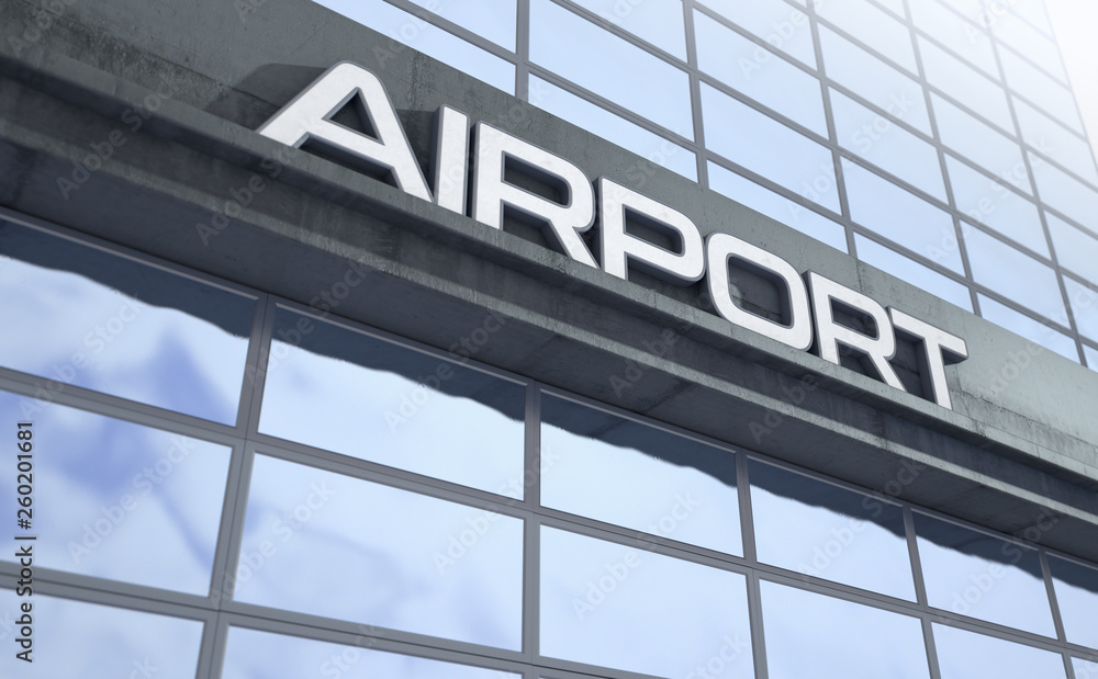 Signage above the entrance to a modern generic airport building made of ...