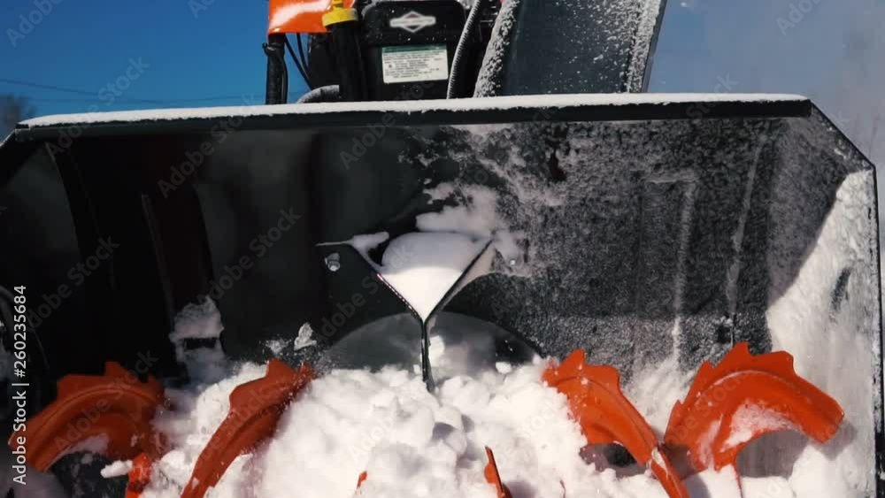 Cleaning the territory with the help of a snowblower during a snowfall ...