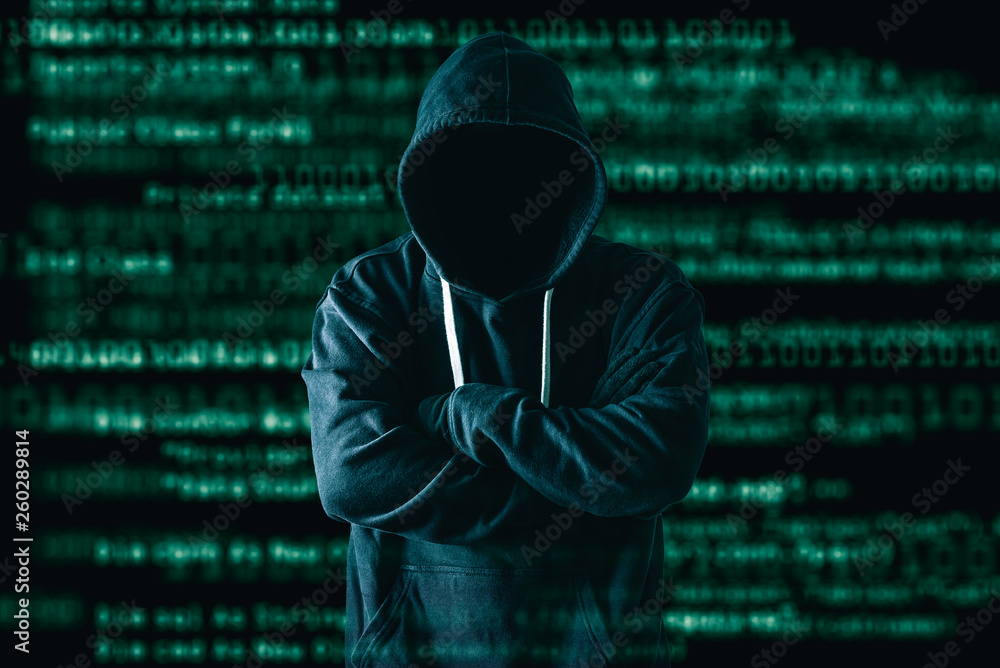 The abstract image of the hacker standing and the binary code image is ...