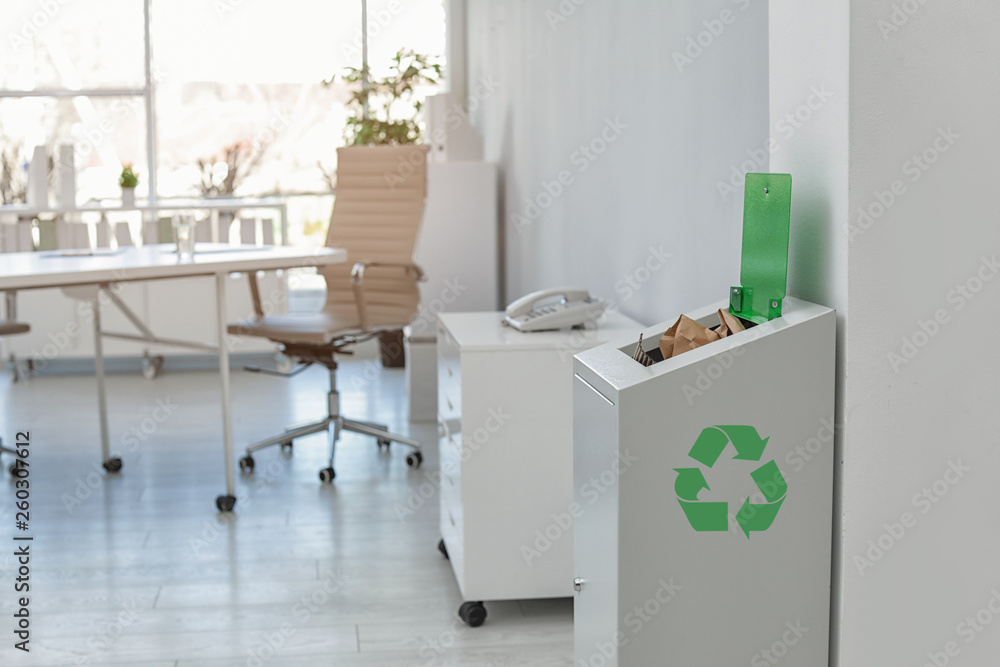 Open full trash bin in modern office, space for text. Waste recycling ...