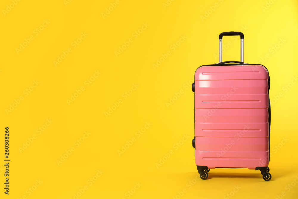 Stylish suitcase on color background. Space for text Stock Photo ...