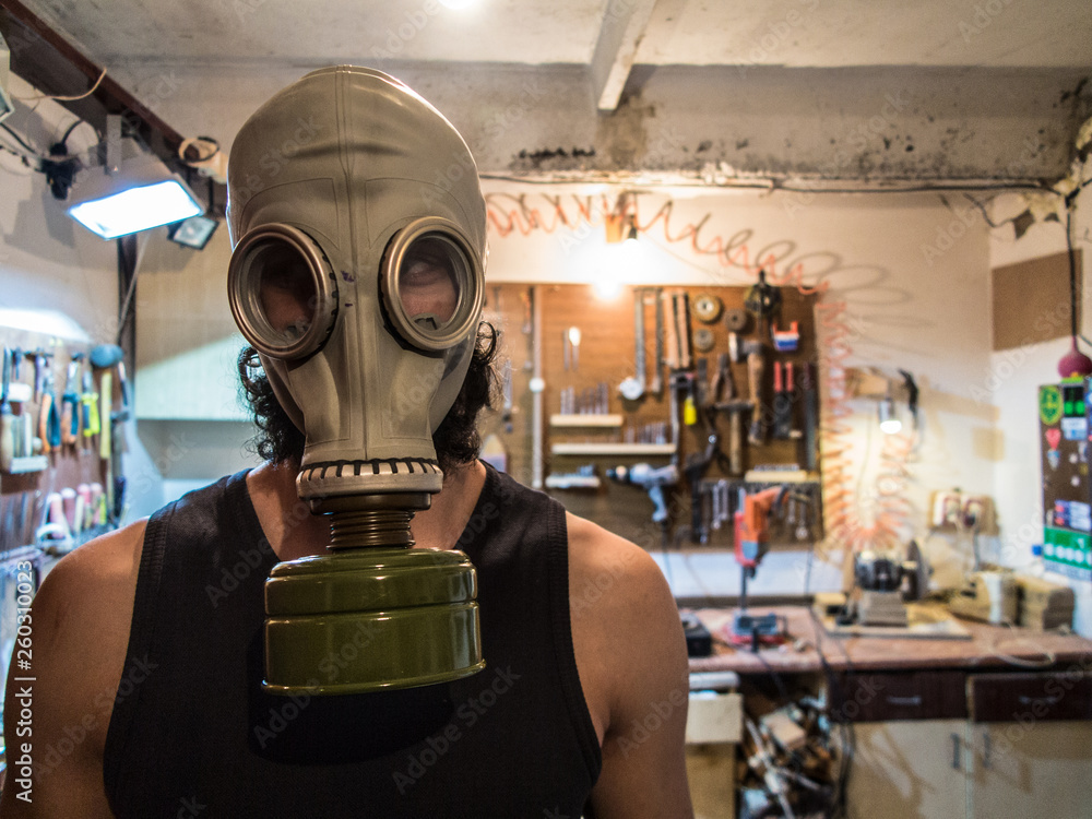 Worker in a workshop wearing soviet military respirator gas mask Stock ...