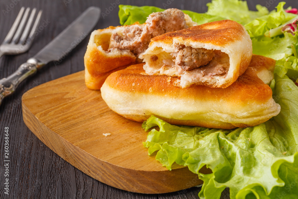 Triangular Russian belyashi with meat Stock Photo | Adobe Stock