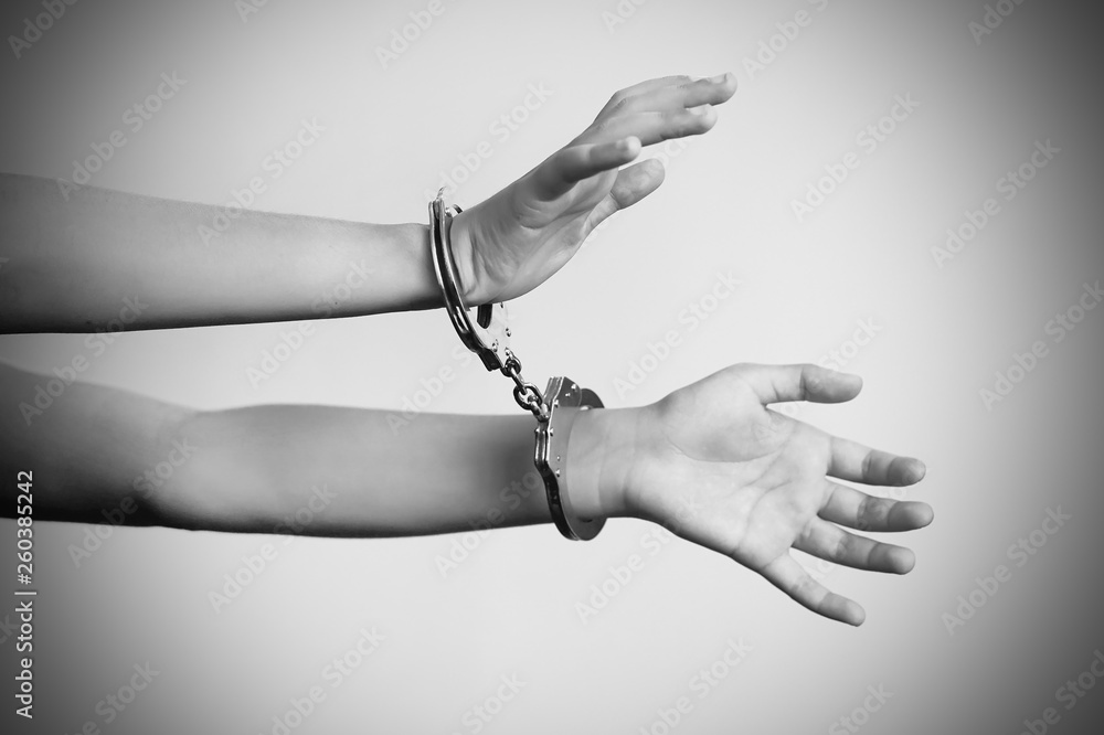Arrested woman handcuffed hands. Prisoner or arrested terrorist, close ...