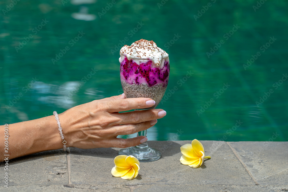 Girl hand holding a glass with hia seeds pudding on the background of ...