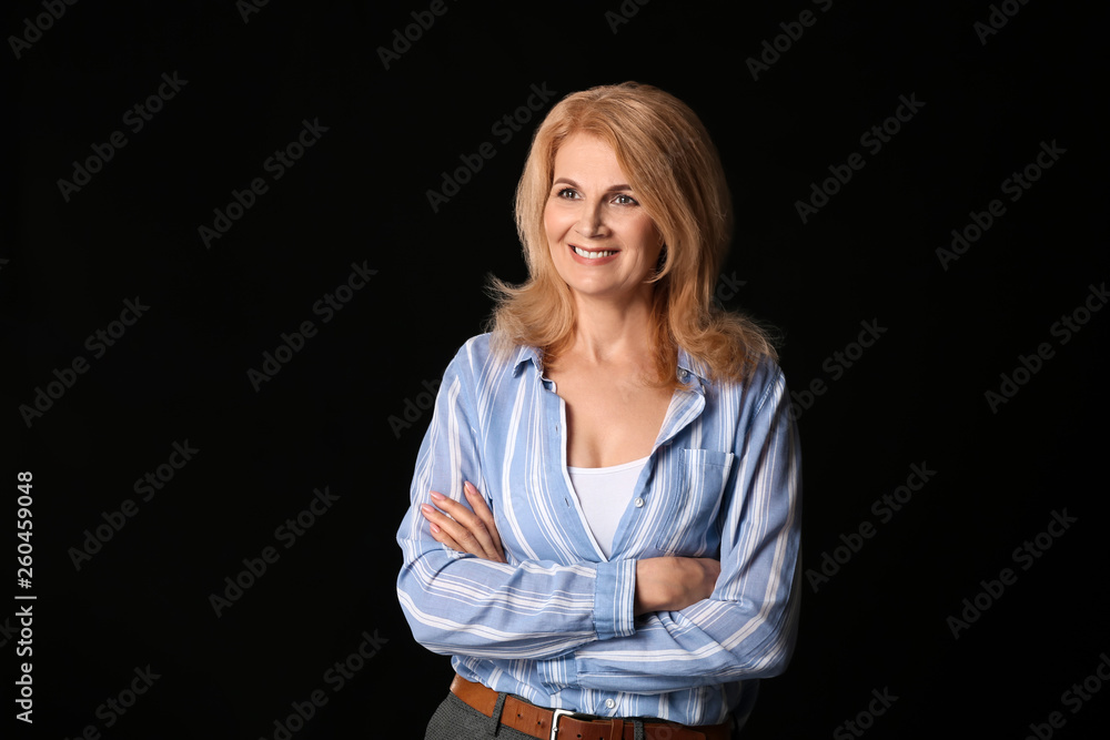 Stylish mature woman on dark background Stock Photo | Adobe Stock