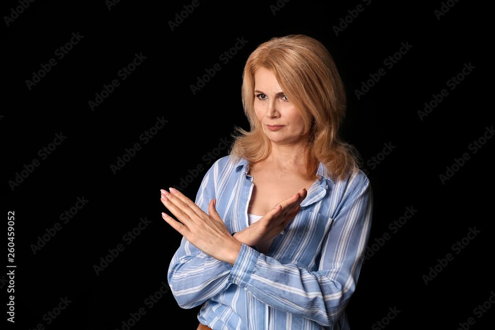 Mature woman rejecting something on dark background Stock Photo | Adobe ...