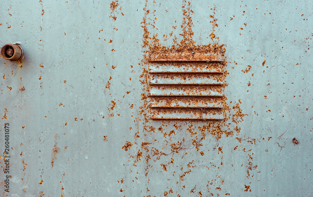 Rusty perforated air vents on steel door in switchboard painted white ...