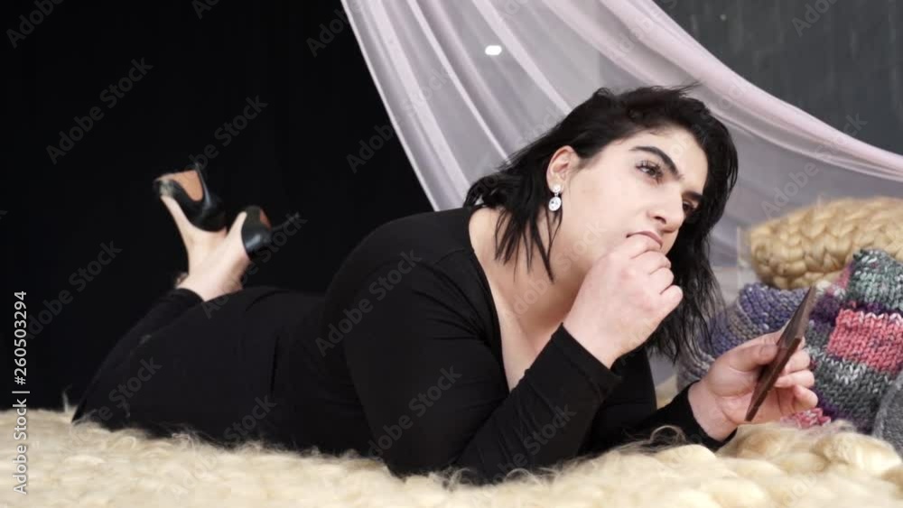 Attractive plus size model lying on bed eating chocolate Stock Video ...