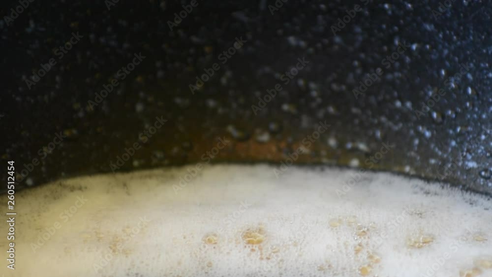 Popcorn is boiled in hot boiling vegetable oil, explodes and shoots up ...