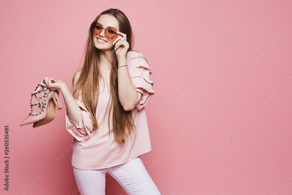 Beautiful and happy blonde model girl with a shiny smile in beige ...