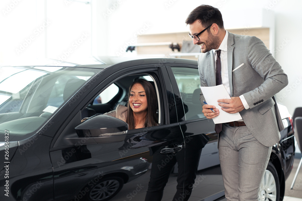 Salesperson at car dealership selling vehicles Stock Photo | Adobe Stock