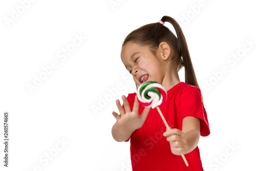 cute little girl with candy lollipop doing stop sign isolated on white ...