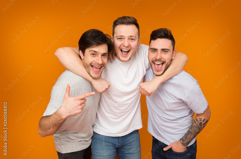 Best friends. Men posing over orange background Stock Photo | Adobe Stock
