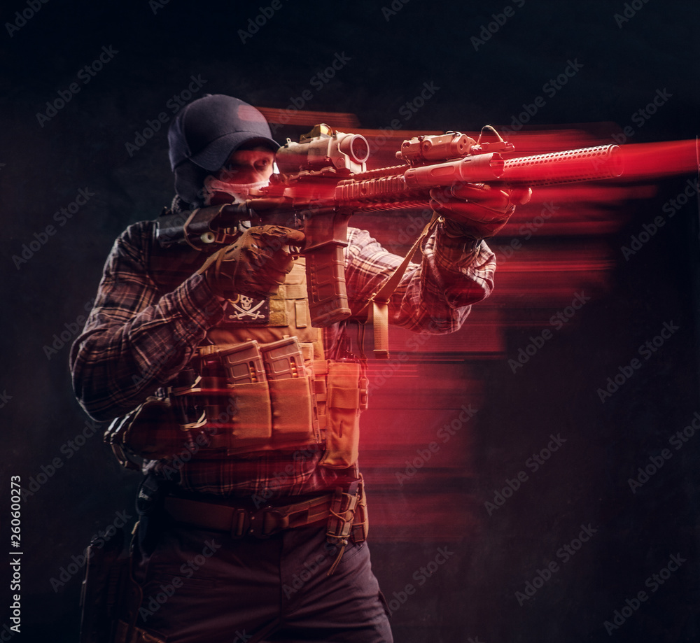 Special forces soldier wearing a checkered shirt and protective ...