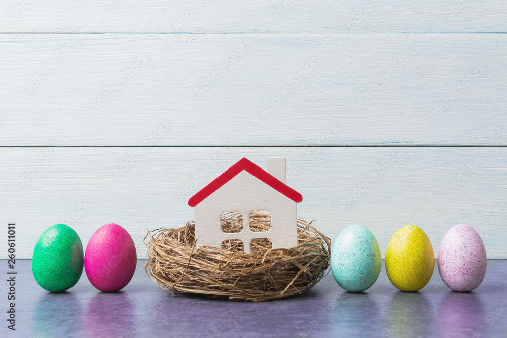Easter concept with house model in nest and painted eggs Stock Photo ...