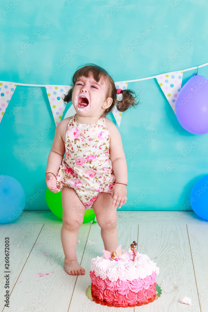 Little girl at first birthday party smash the cake crying Stock Photo ...