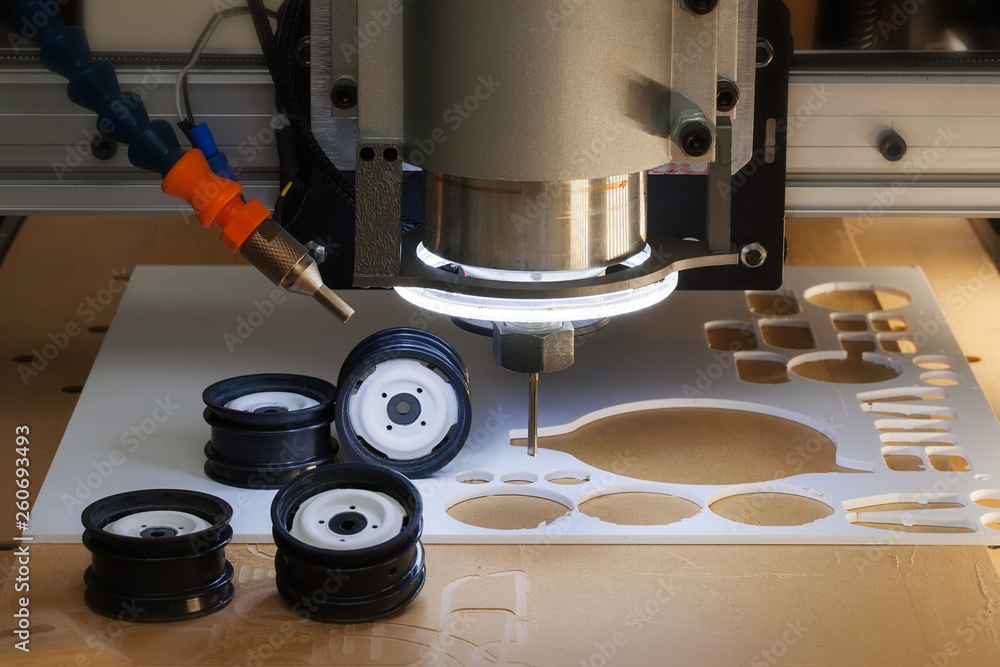 Desktop CNC machine used to make scale model rims and wheels from ABS ...