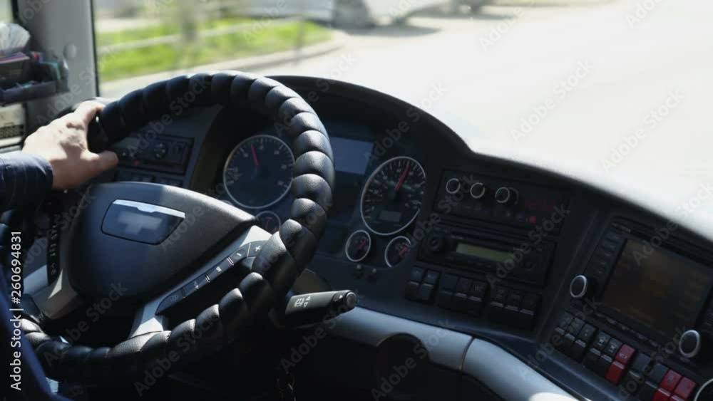 Bus driver behind the wheel of long-distance coach. Man driving a ...