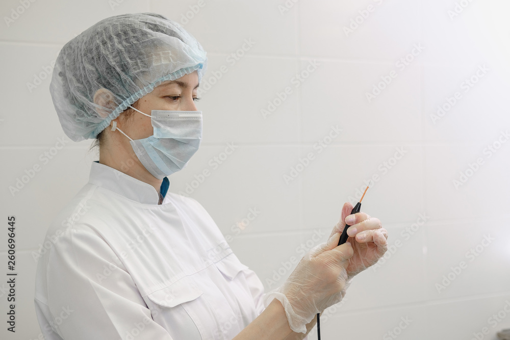 Female Dermatologist Surgeon Preparing A Professional Electrocautery