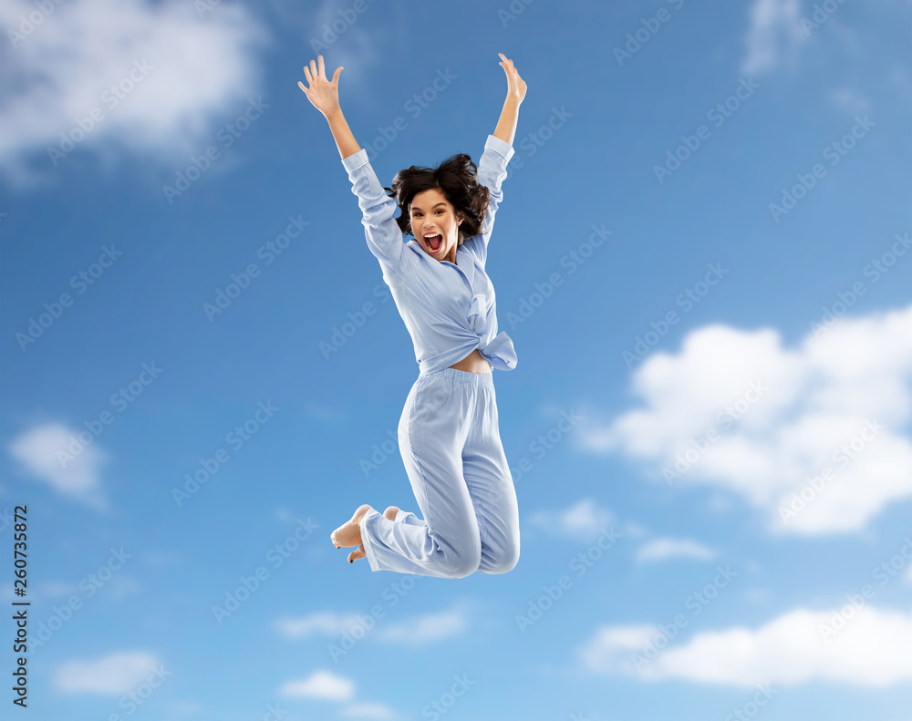 fun, people and bedtime concept - happy young woman full of energy in ...
