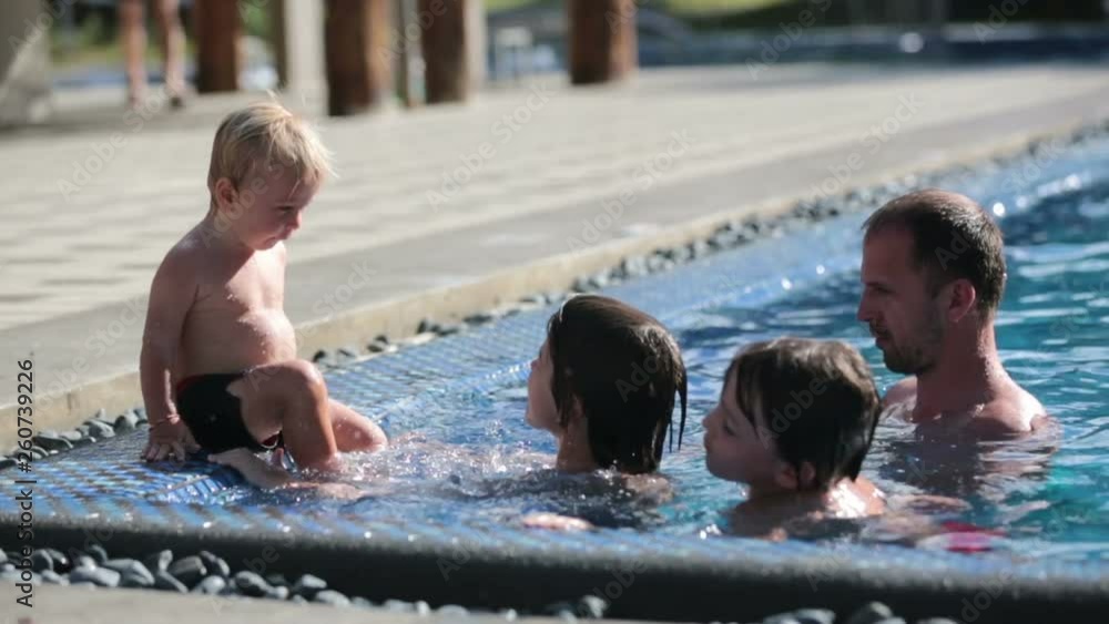 Father and son, playing in the pool, dad learning baby to swin, going ...