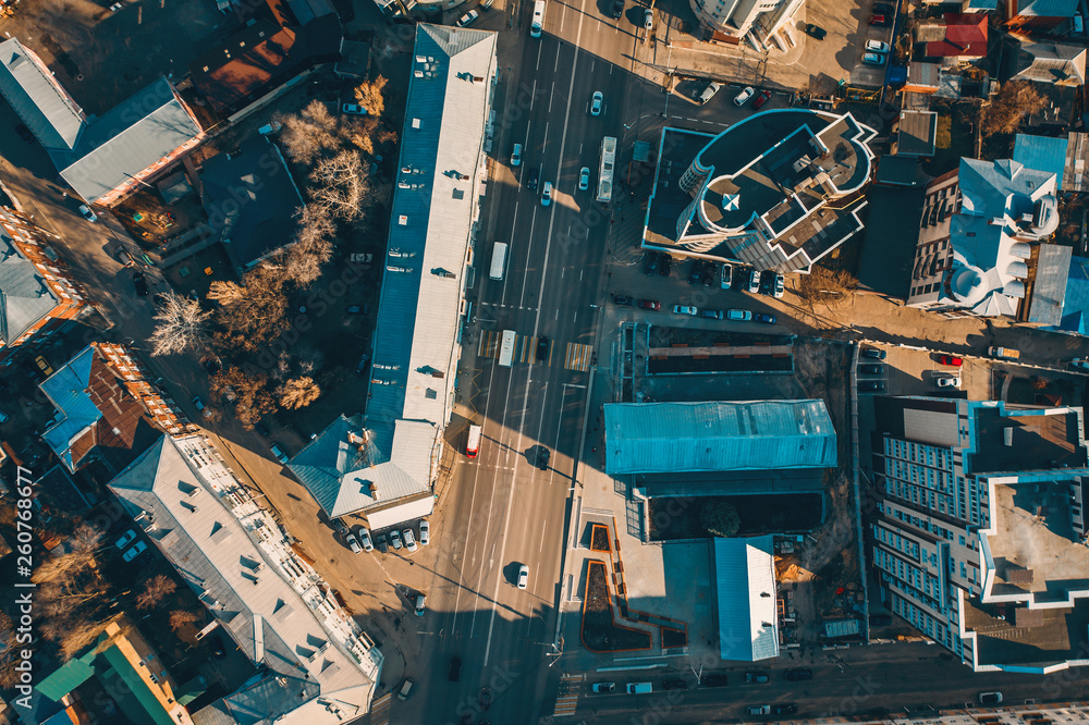 Aerial top down view of road with car traffic among urban high-rise ...