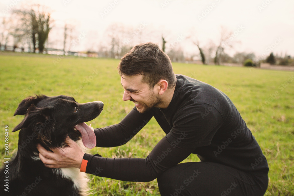 Dog and his owner having fun in a city park. Concepts of friendship ...