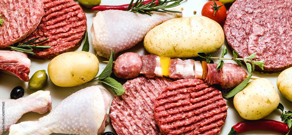 different types of raw meat: chicken thighs, pork and beef burgers ...