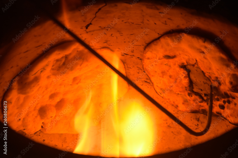 man making a tandoori roti on fire, Indian Food Stock Photo | Adobe Stock