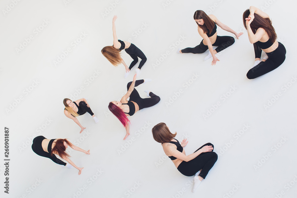 Fitness, stretching practice, group of two attractive happy smiling fit ...