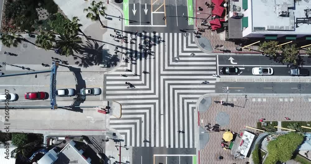 Pedestrians crossing at the beach through an intersection crosswalk in ...