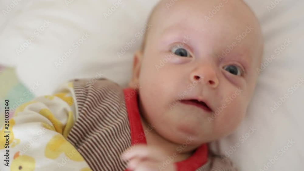 baby boy is awake. the child has very mobile facial expressions. face ...