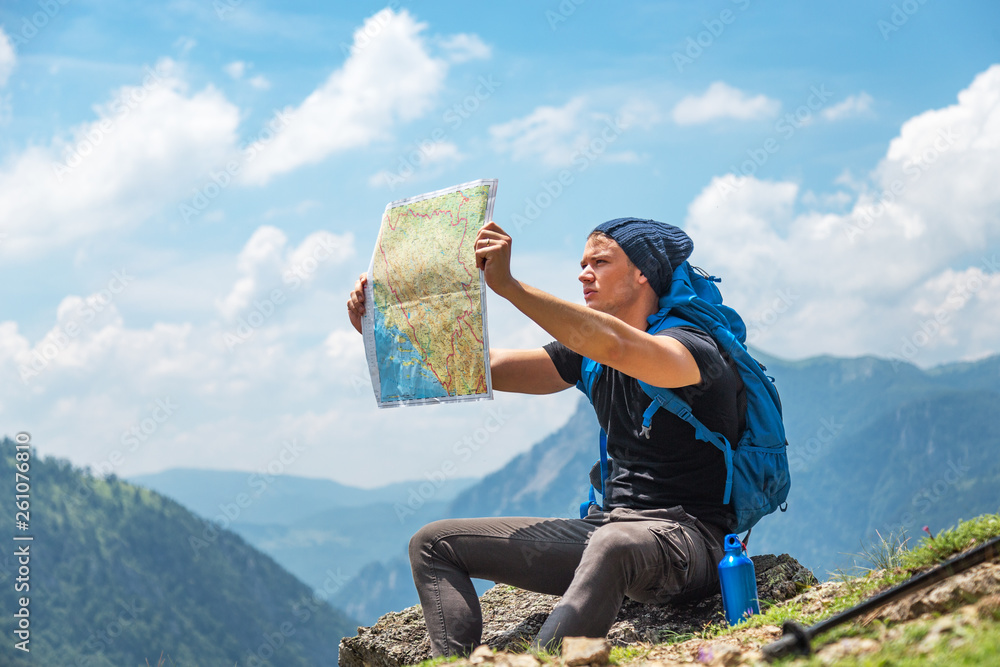 Male handsome hiker using map to navigate in nature Stock Photo | Adobe ...