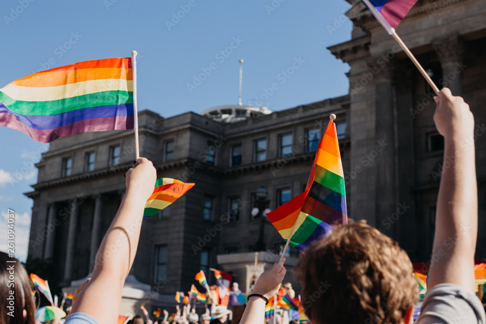 Crowd of people waving rainbow flags at pride parade Stock Photo ...