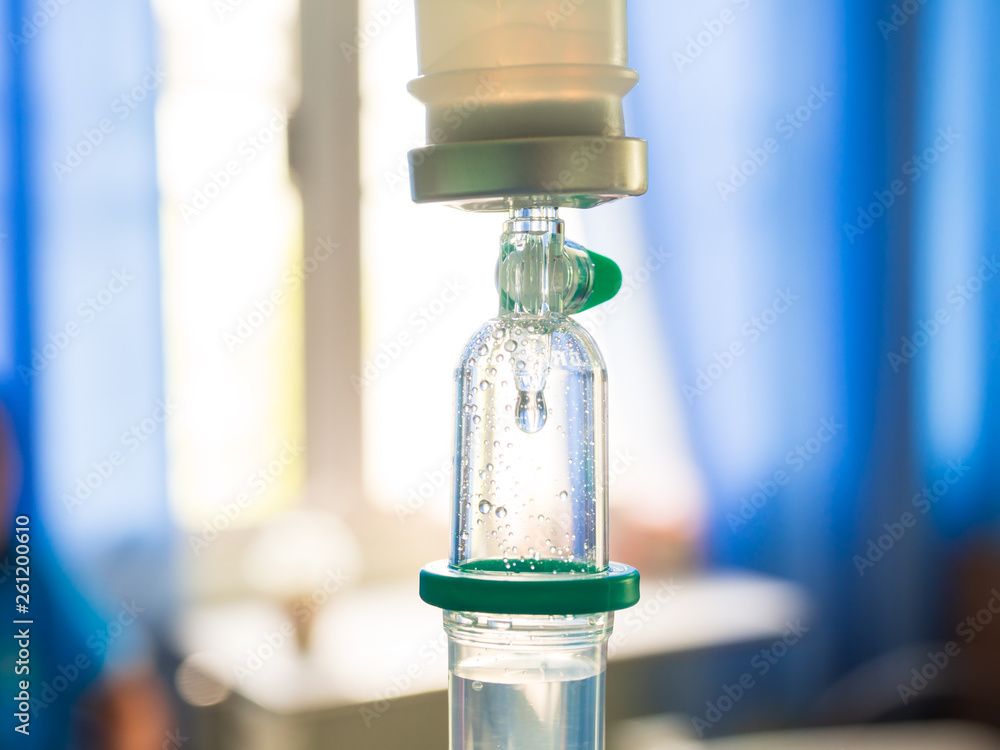 Close up nurse hand adjust set iv fluid intravenous drop saline drip in ...