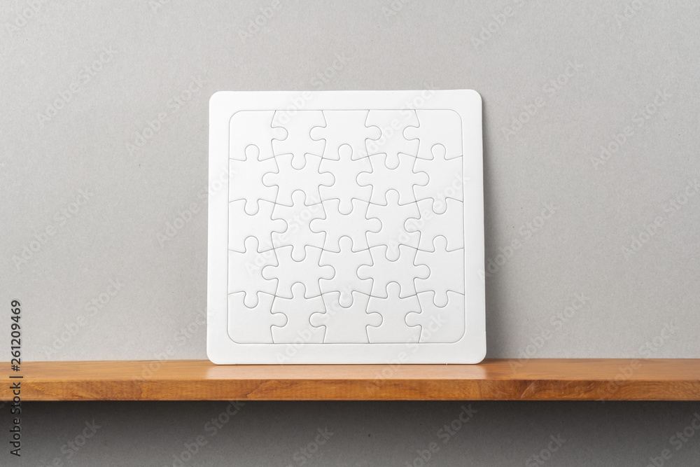 white square jigsaw puzzle on bookshelf Stock Photo | Adobe Stock