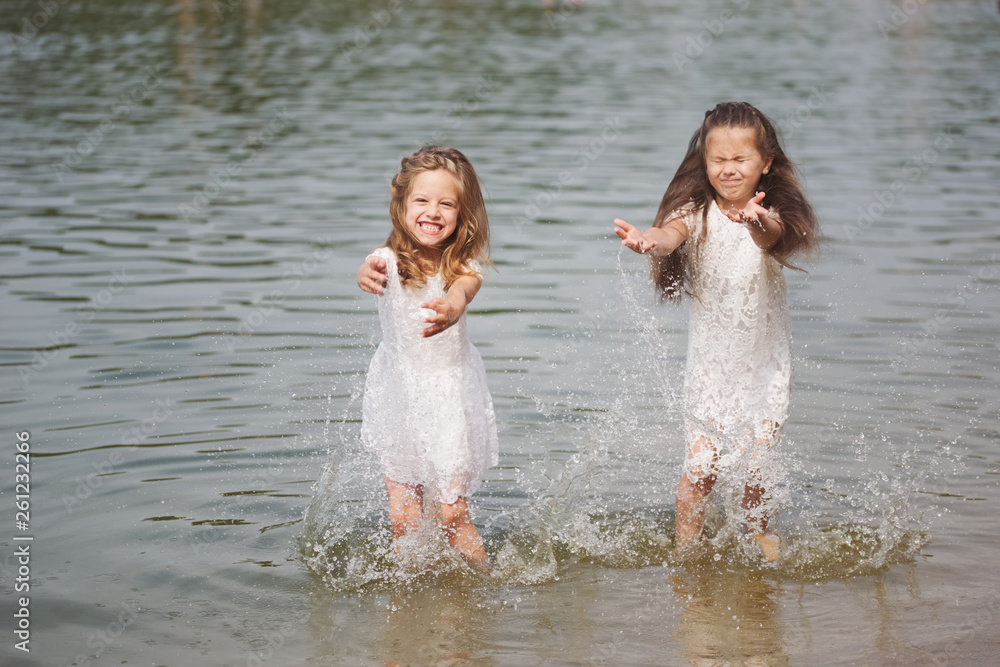 cute happy little girls in sumer lake Stock Photo | Adobe Stock