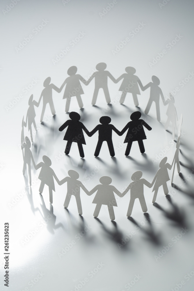 Three human paper figures surrounded by circle of paper people holding ...